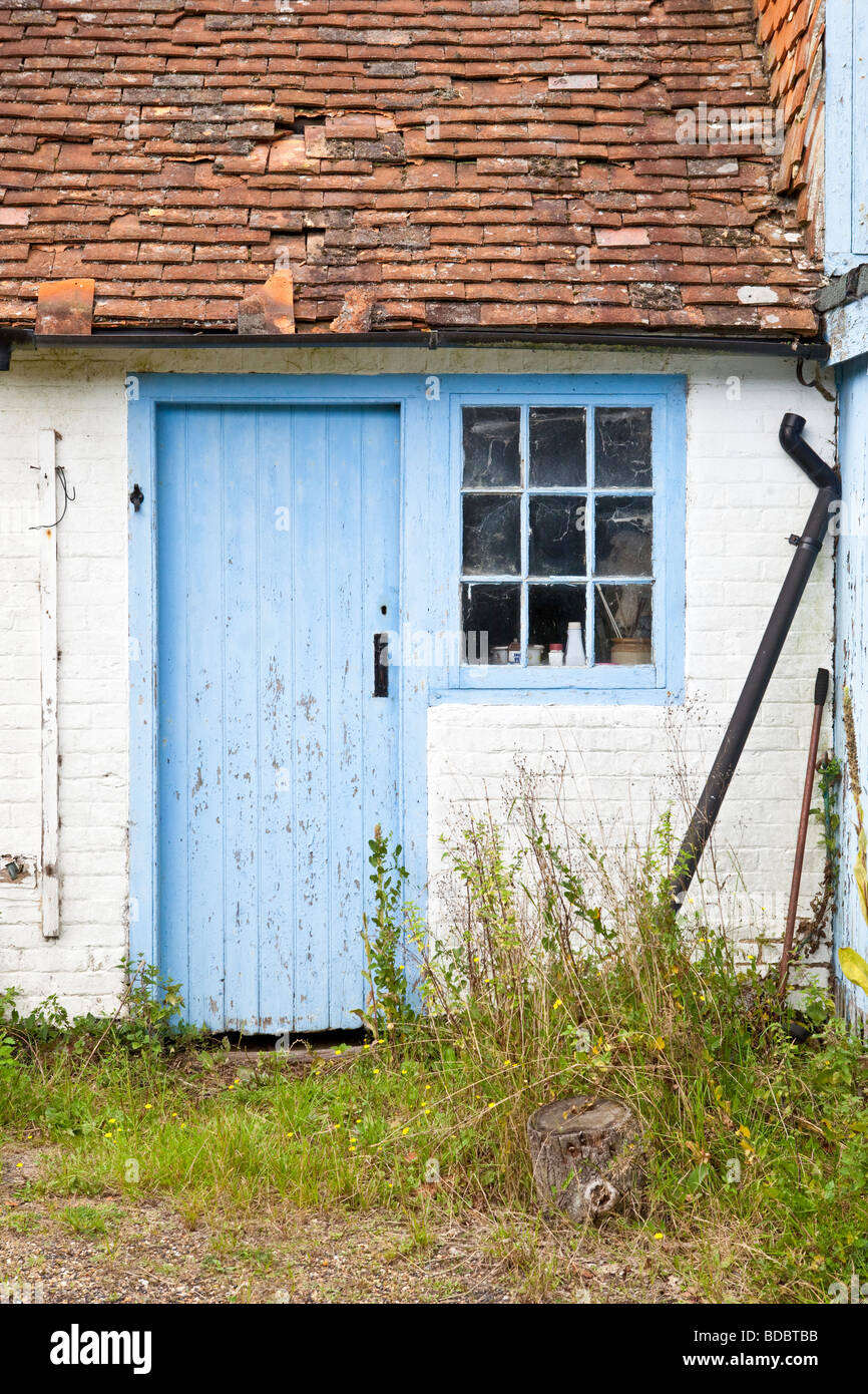 blue door farm door overgrown stable Stock Photo - Alamy
