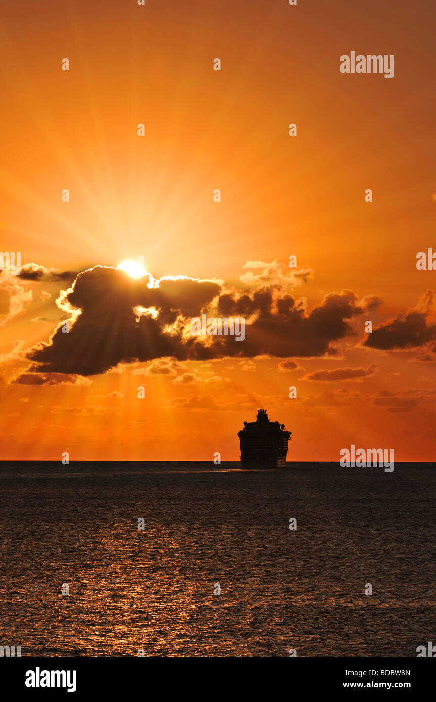 Cruise ship sailing into the sunset with sunburst effect Stock Photo ...