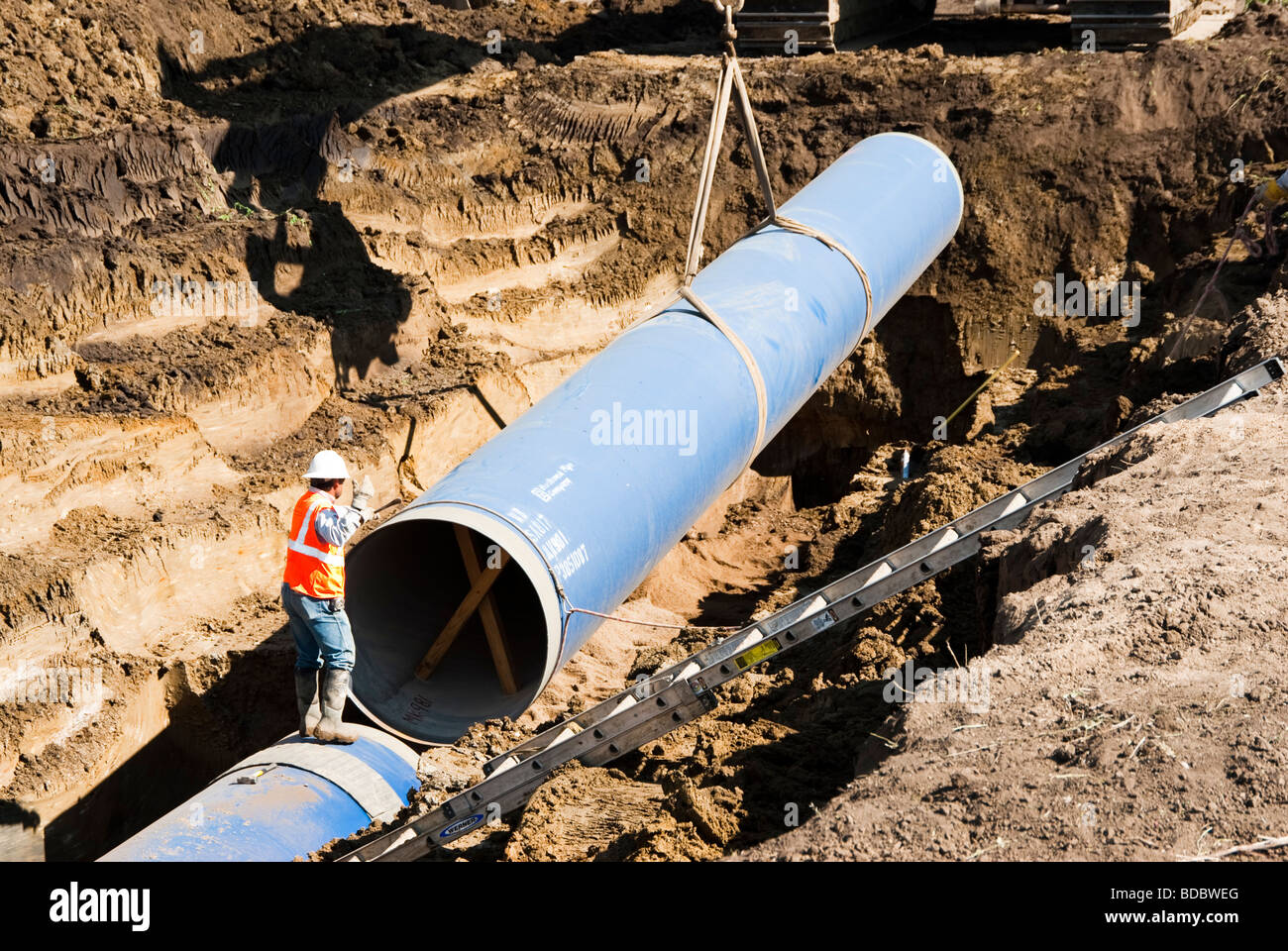 Water pipe being laid at the Louis Clark Regional Water System pipeline ...