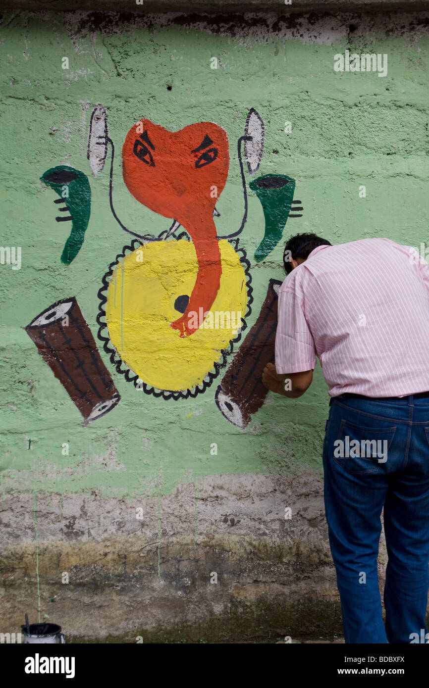 Indian graffiti artist paints an image of hindu god Ganesha on a wall ...