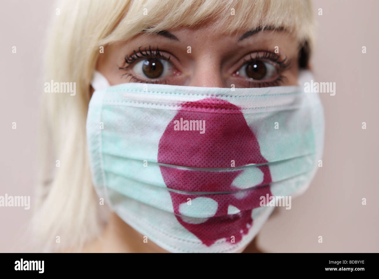 A scared girl stares into the camera. She wears a customized surgical ...