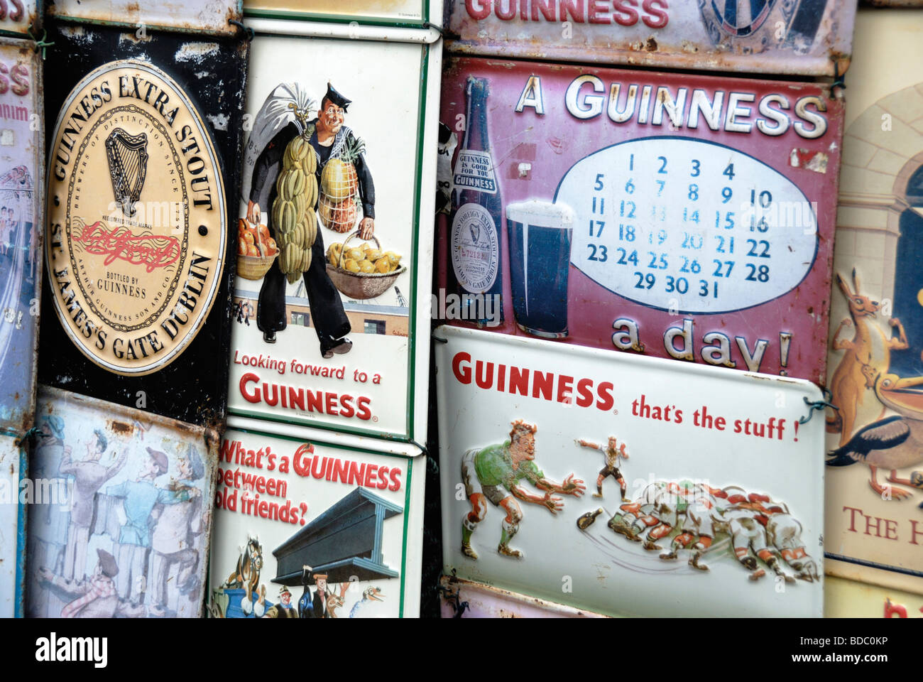 Numerous old tin advertising signs promoting Guinness beer Stock Photo ...