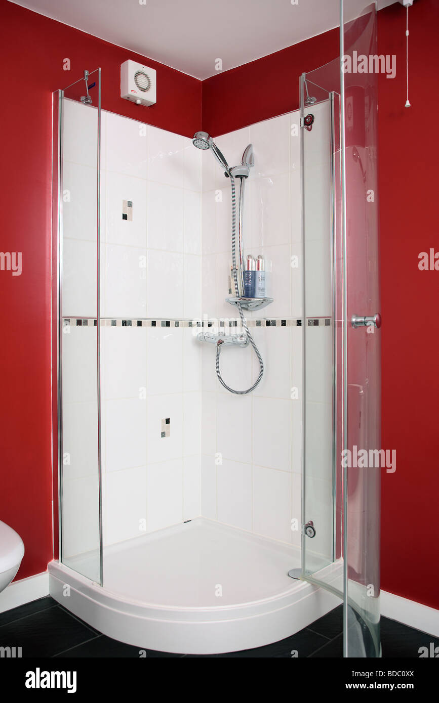 Close up of white tiled shower cabinet with perspex doors in red ...