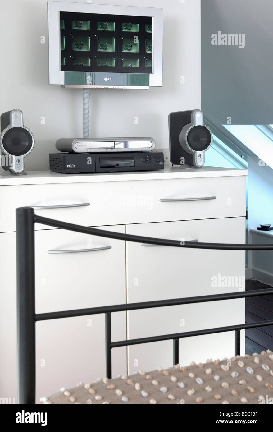 Flat-screen television and small hi fi on white fitted cupboard in ...