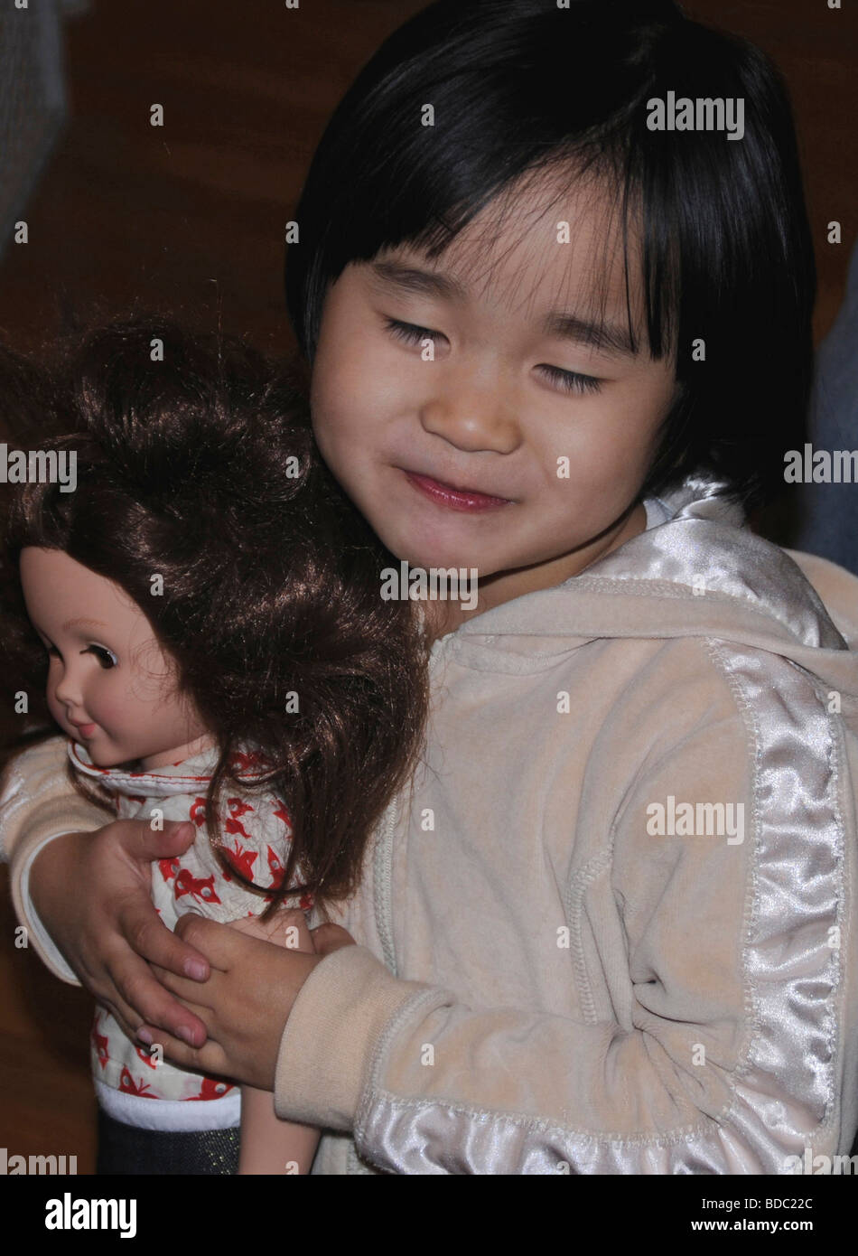 Small child with her doll Stock Photo - Alamy