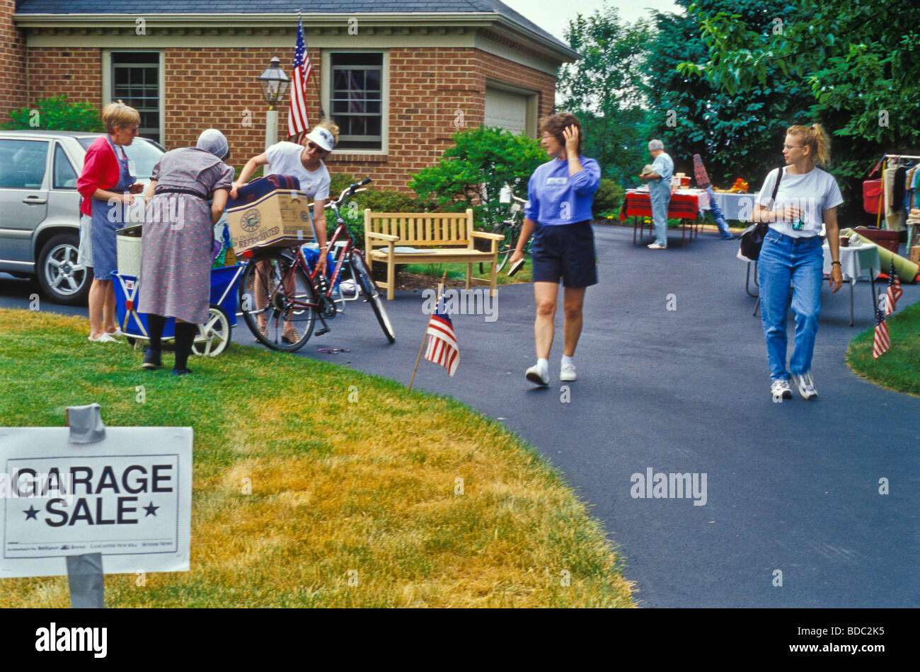 Shopper at small town suburban yard sale Stock Photo - Alamy