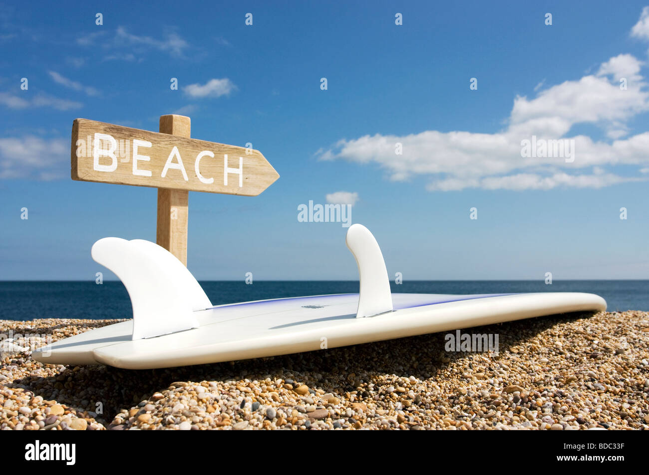 Surfboard with beach sign Stock Photo - Alamy
