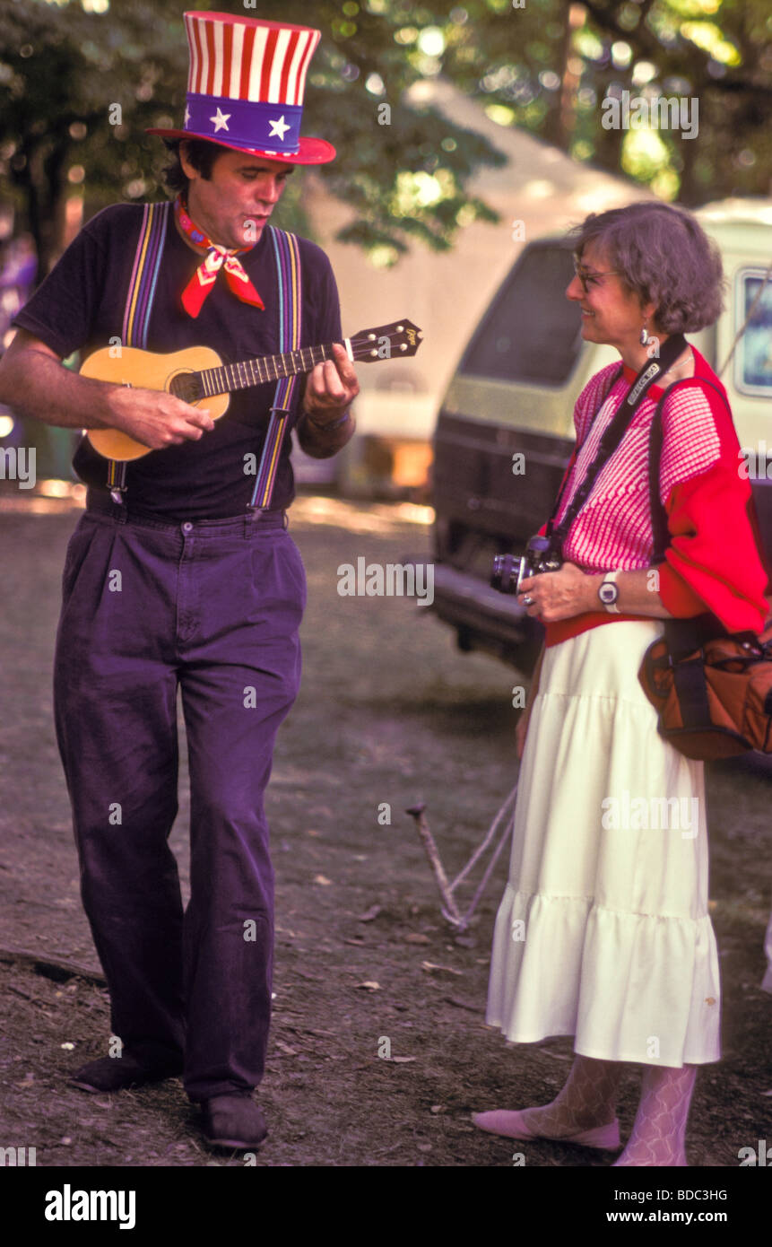 Touring Uncle Sam character musician serenades woman at park picnic ...