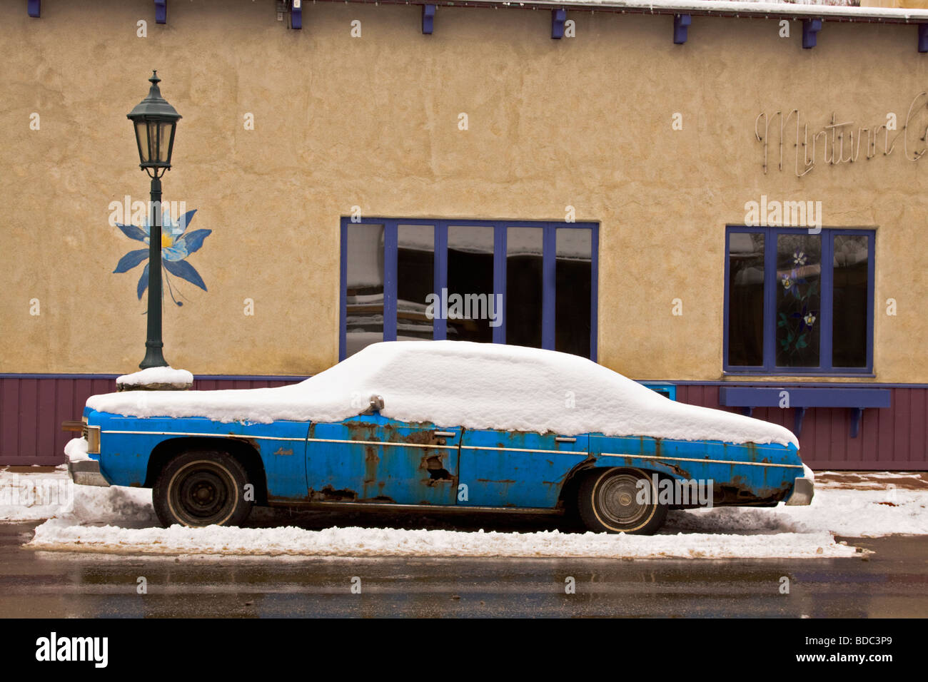 An old rusty car parked on the street in a small Colorado town Stock ...