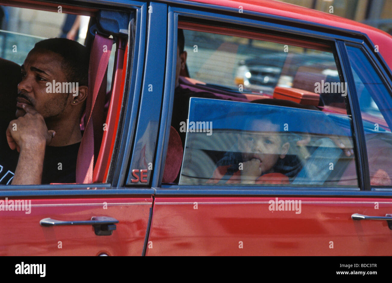 Family in red car Stock Photo - Alamy