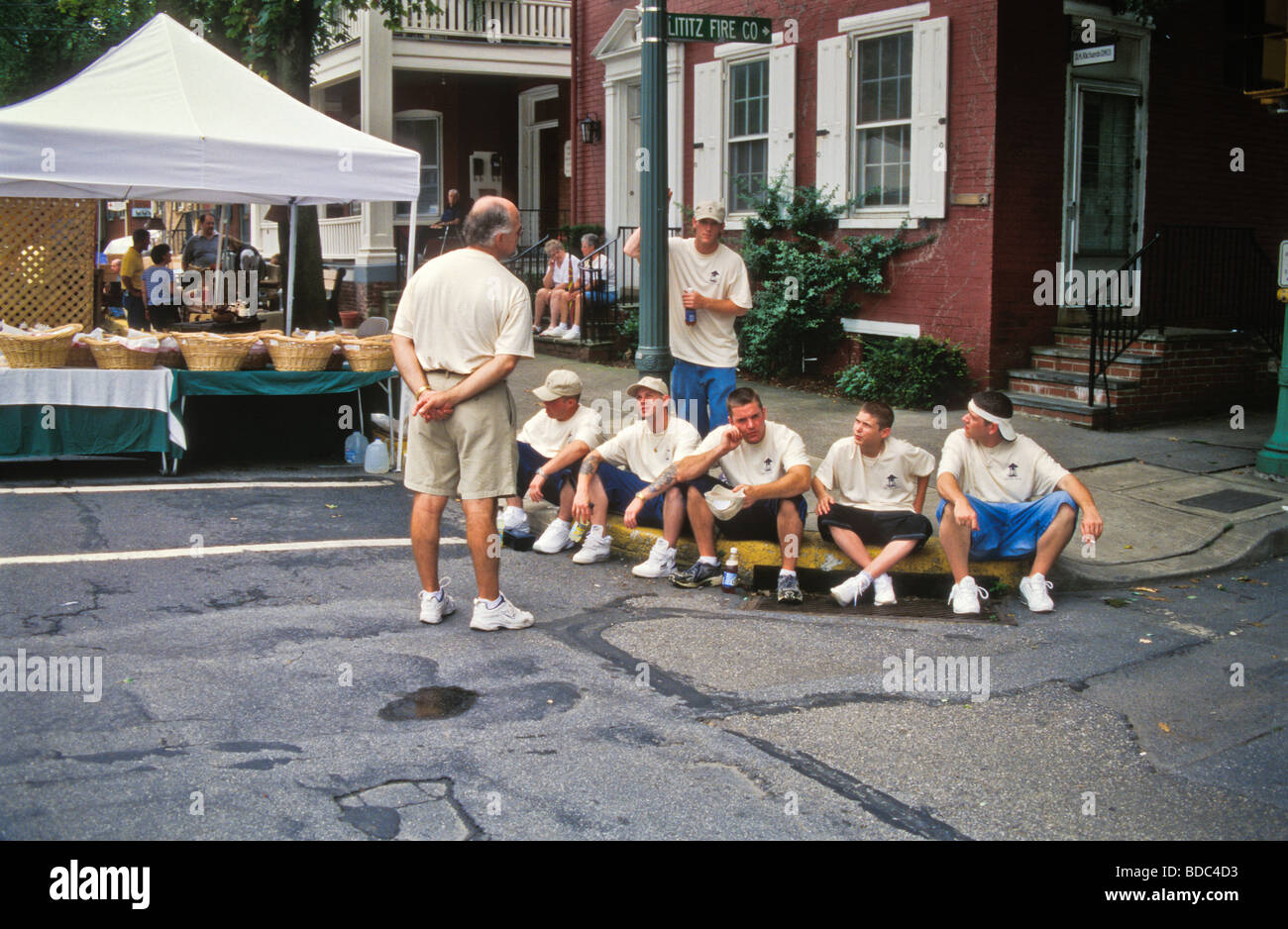 Neighborhood street gathering before small town parade Stock Photo - Alamy