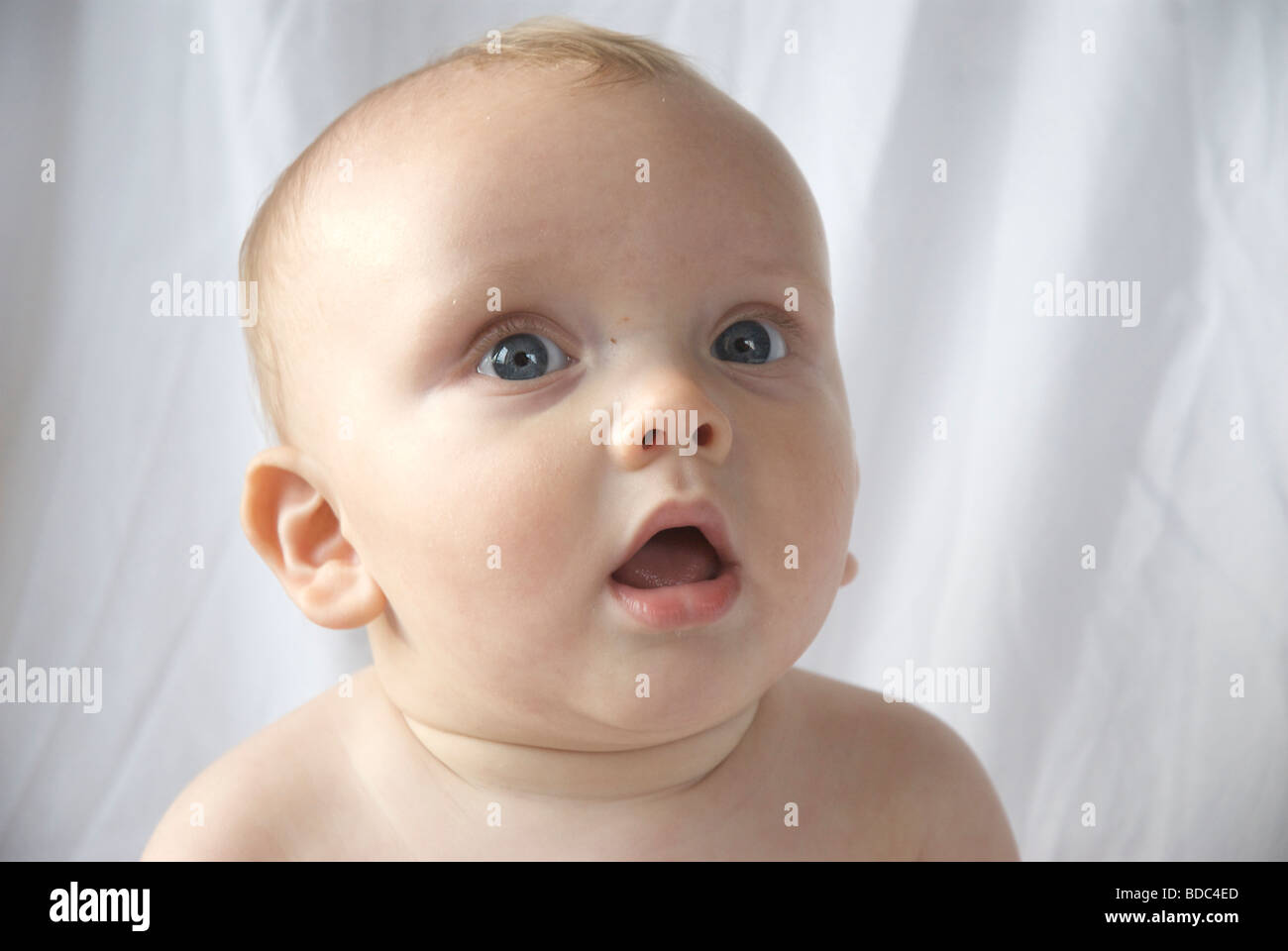 A surprised and confused looking on the baby's face Stock Photo - Alamy