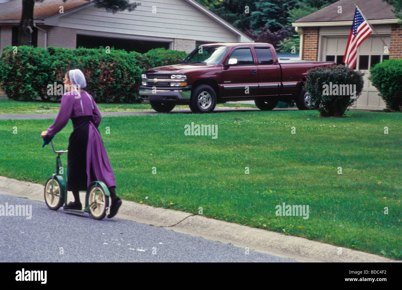 young amish woman riding her scooter bike, searches for bargains at ...