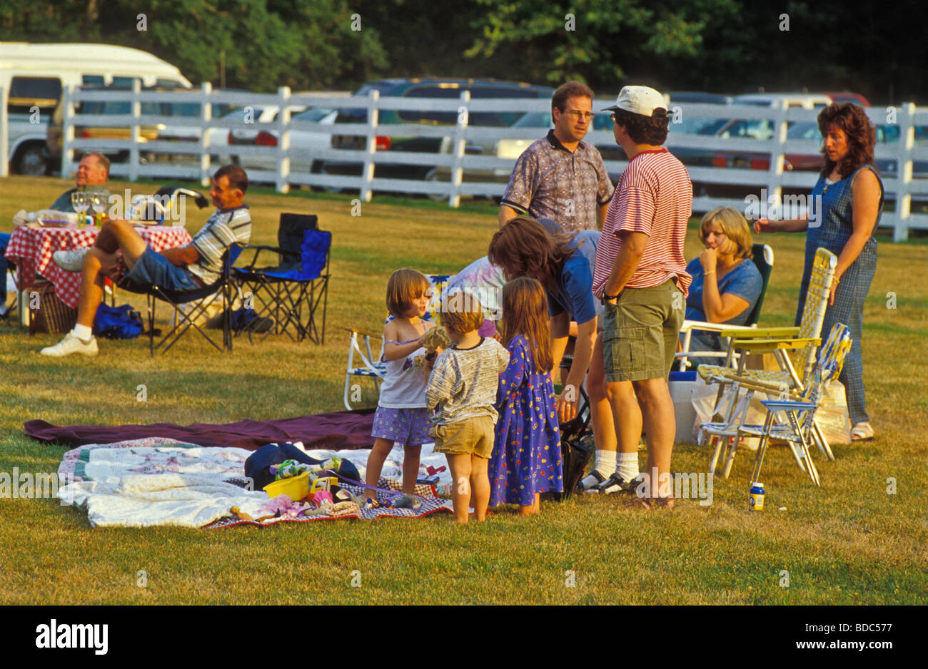 small group of families at summer evening concert Stock Photo - Alamy