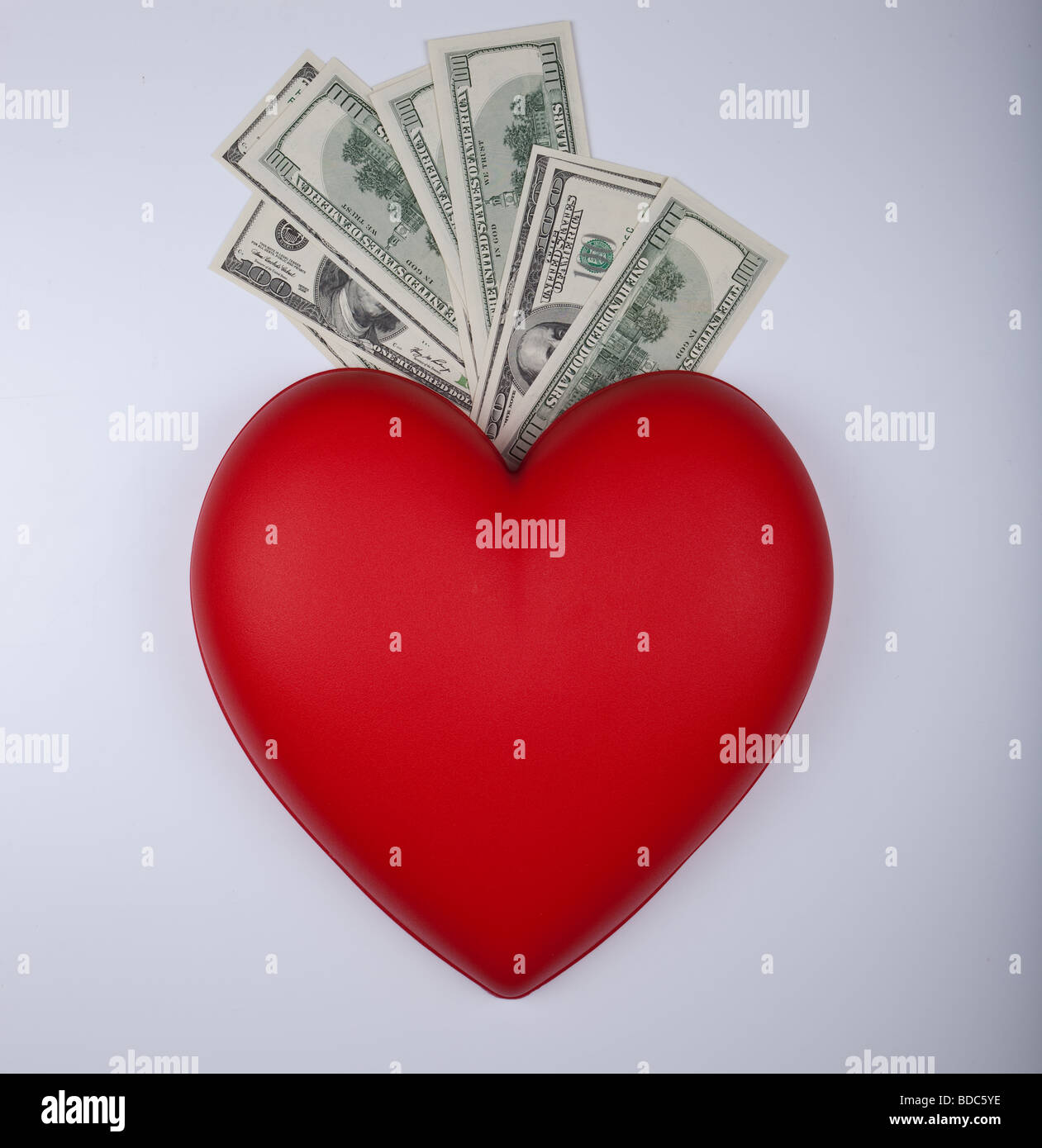 Red plastic heart lies on a white plastic background Stock Photo - Alamy