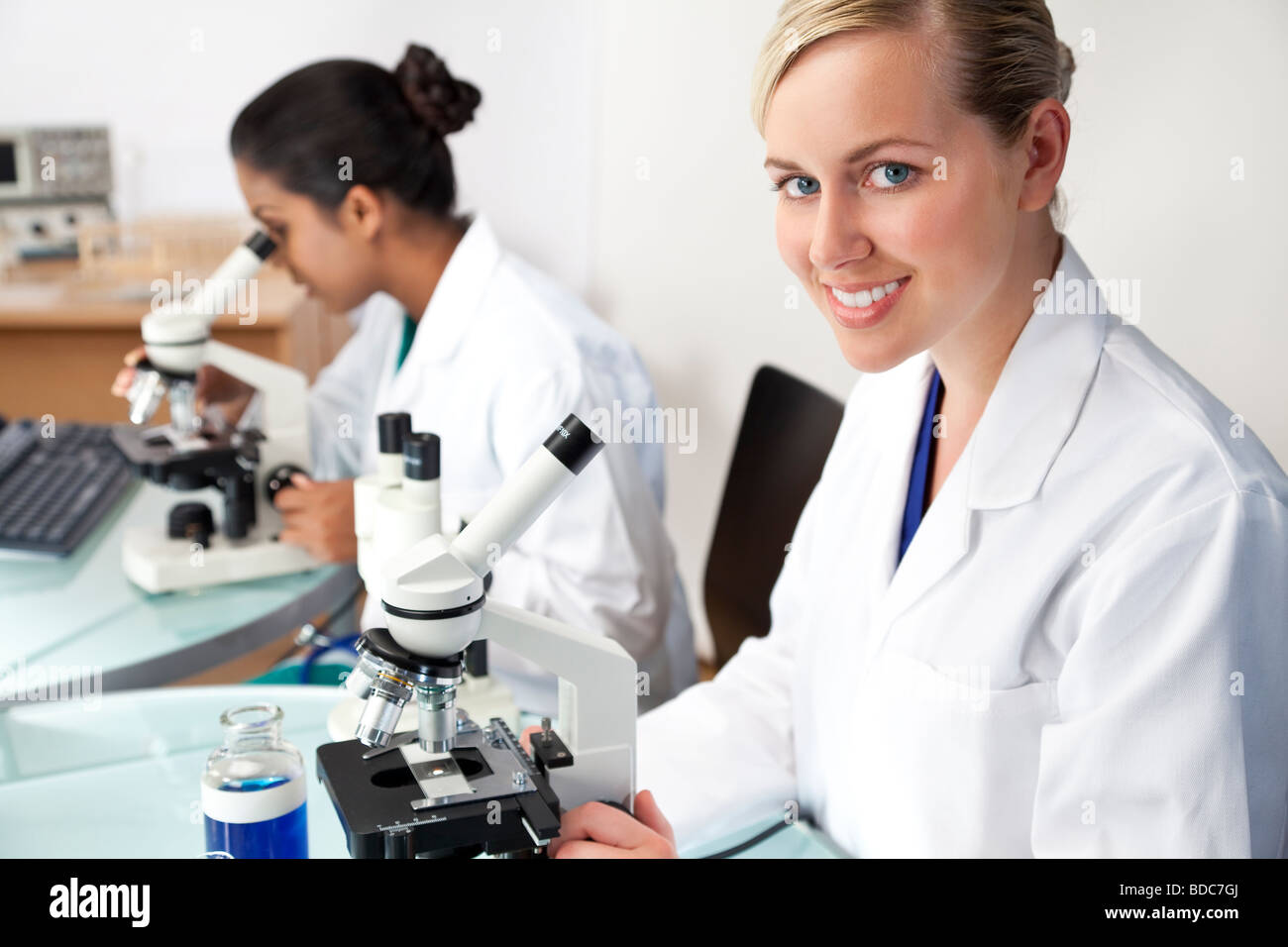 A blond female medical or scientific researcher or doctor using her ...