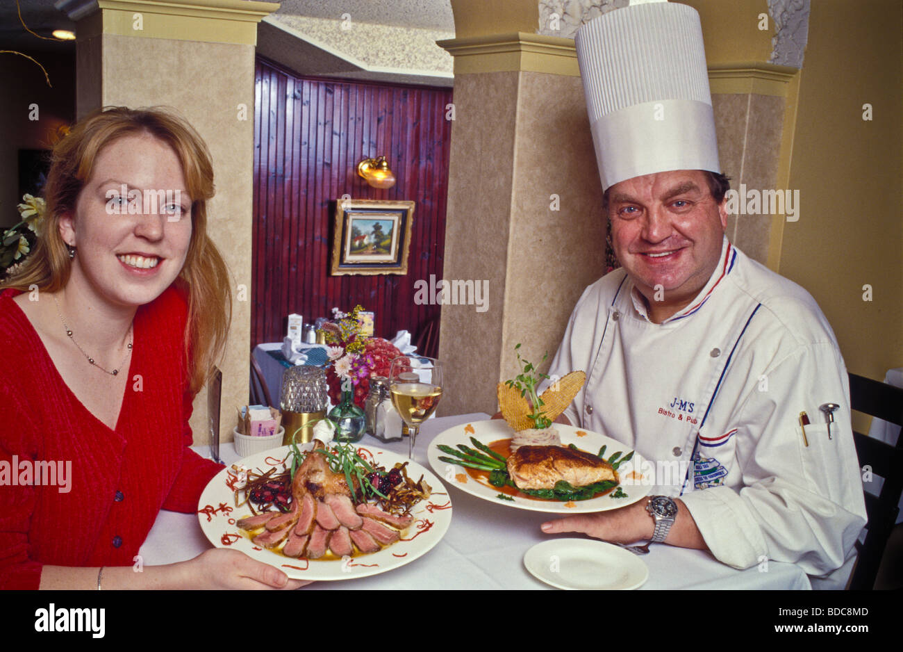 Chef and daughter display two plates of restaurants special gourmet ...