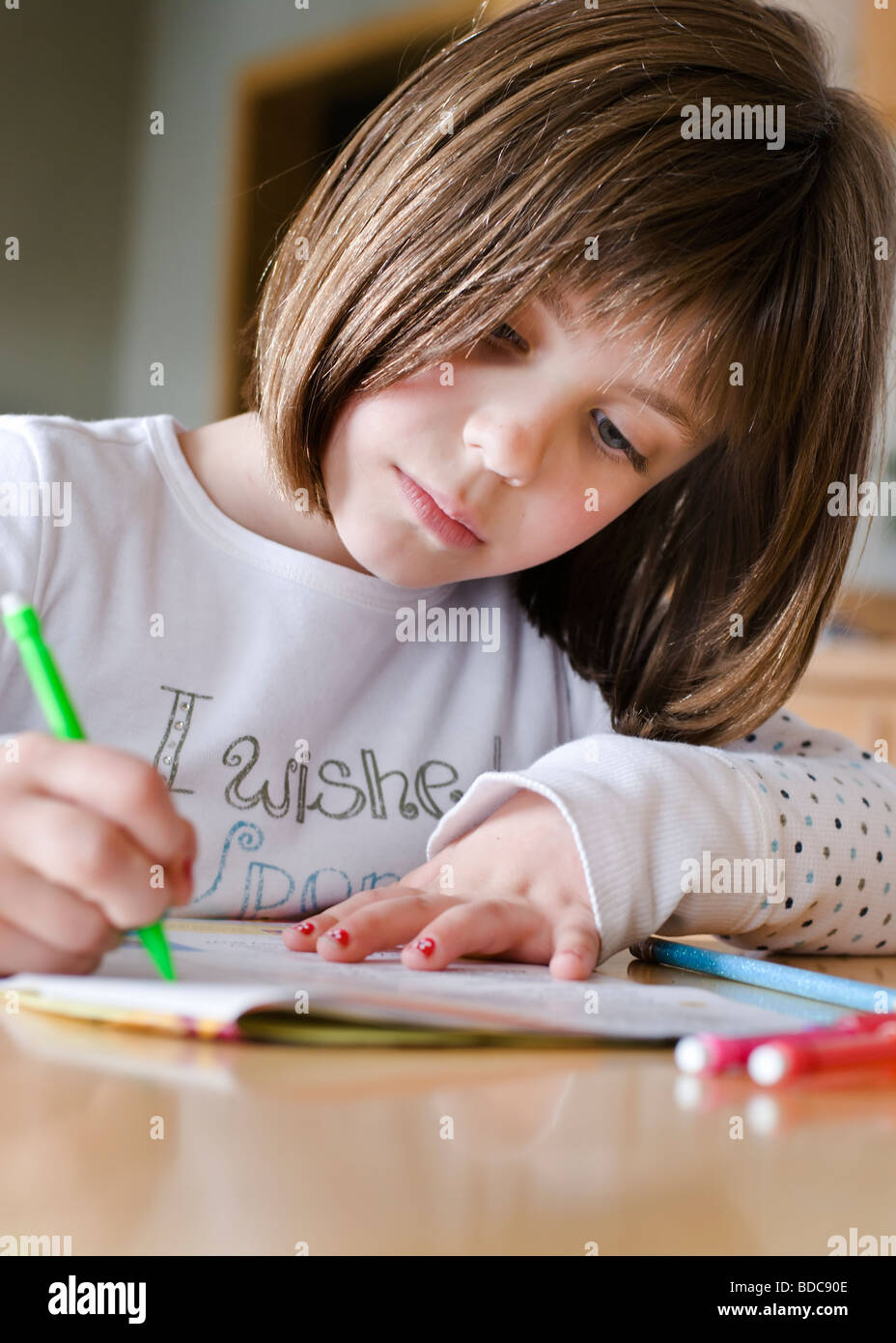A little girl concentrates on her homework after school Stock Photo - Alamy