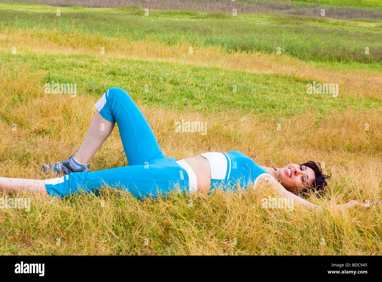 woman relaxing in a field outdoors Stock Photo - Alamy