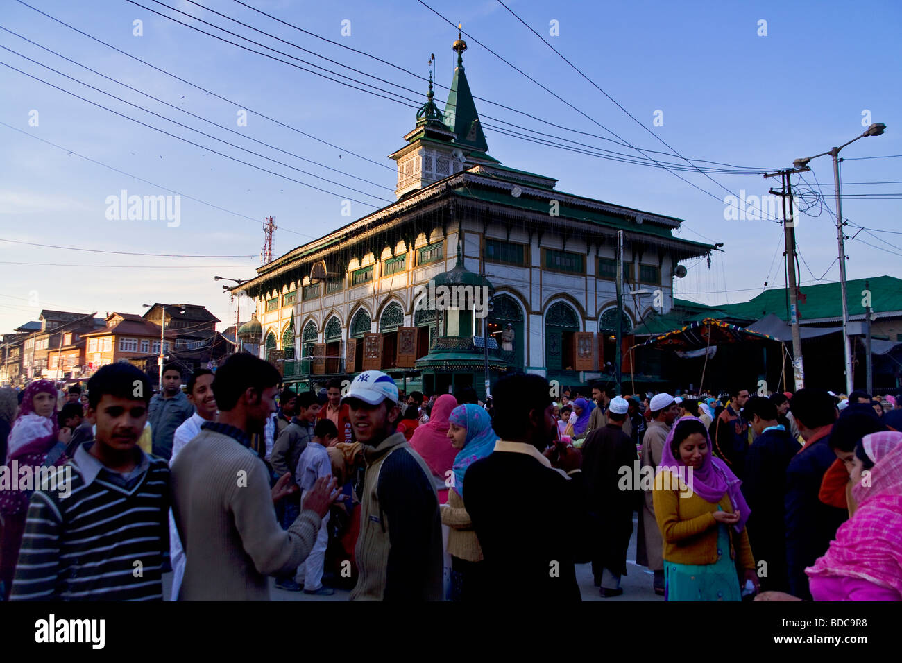 Crowd of people outside a city mosque celebrating a local festival ...
