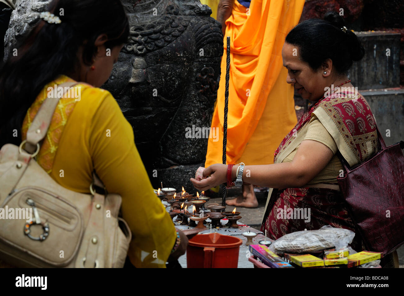 woman buying offertory candles Black Bhairab pray offer worship ritual ...