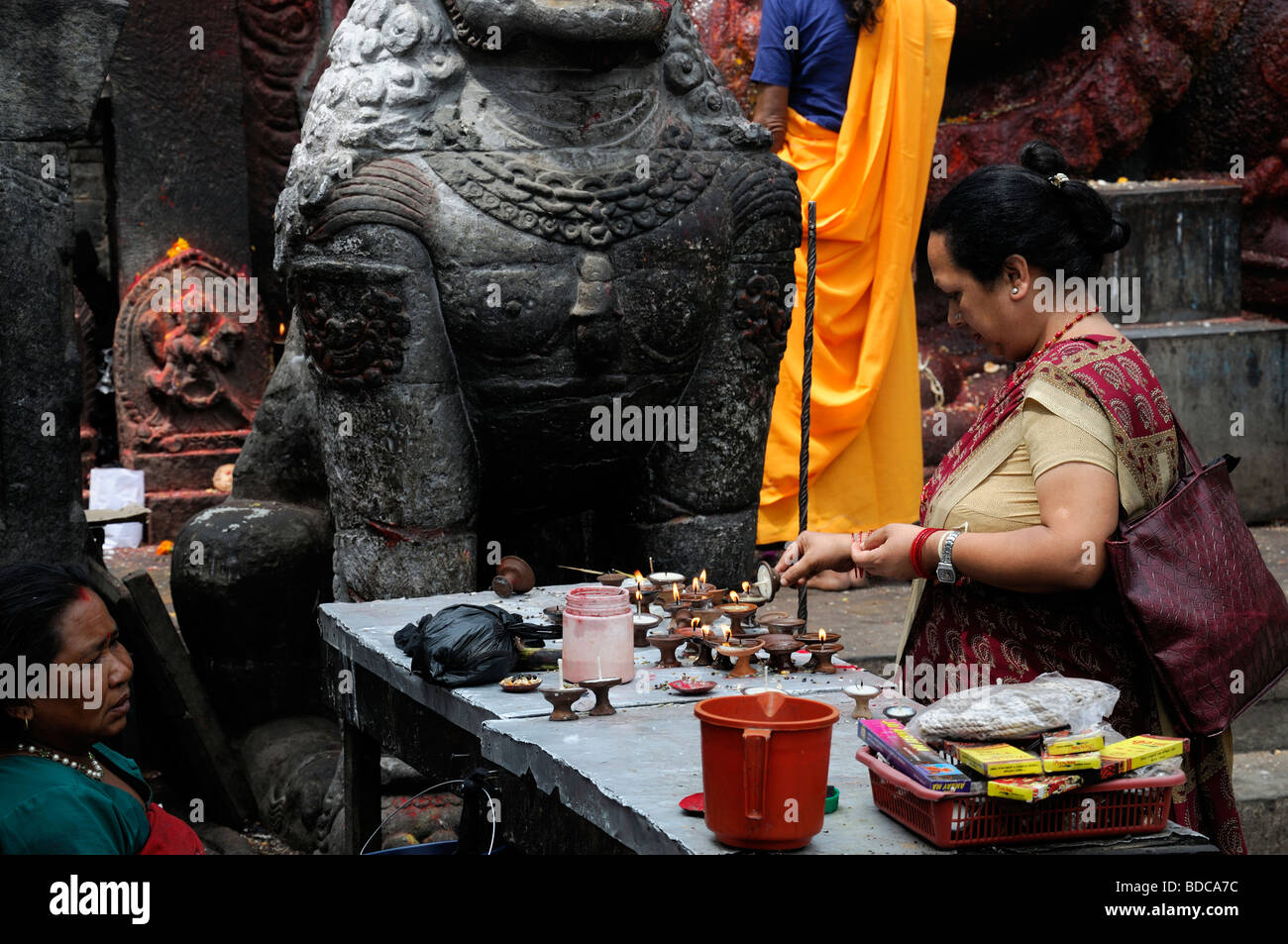 woman buying offertory candles Black Bhairab pray offer worship ritual ...