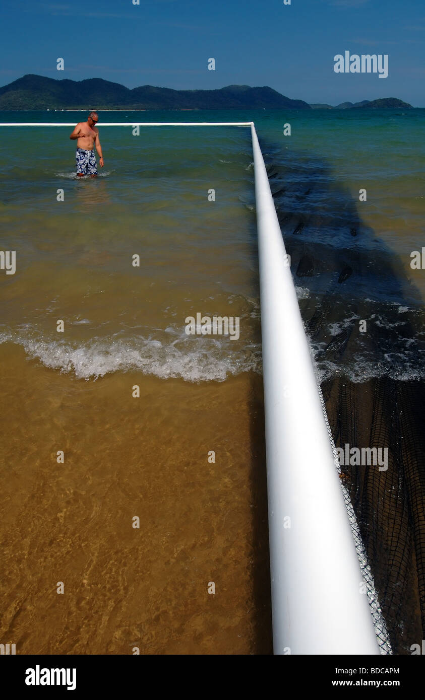 Swimmer inside protective stinger net that keeps dangerous jellyfish ...