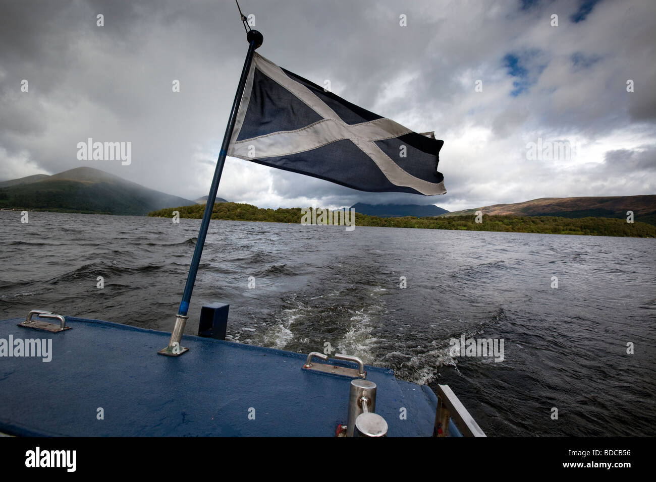 The Saltire flag of Scotland flying on the stern of a tourist boat on ...