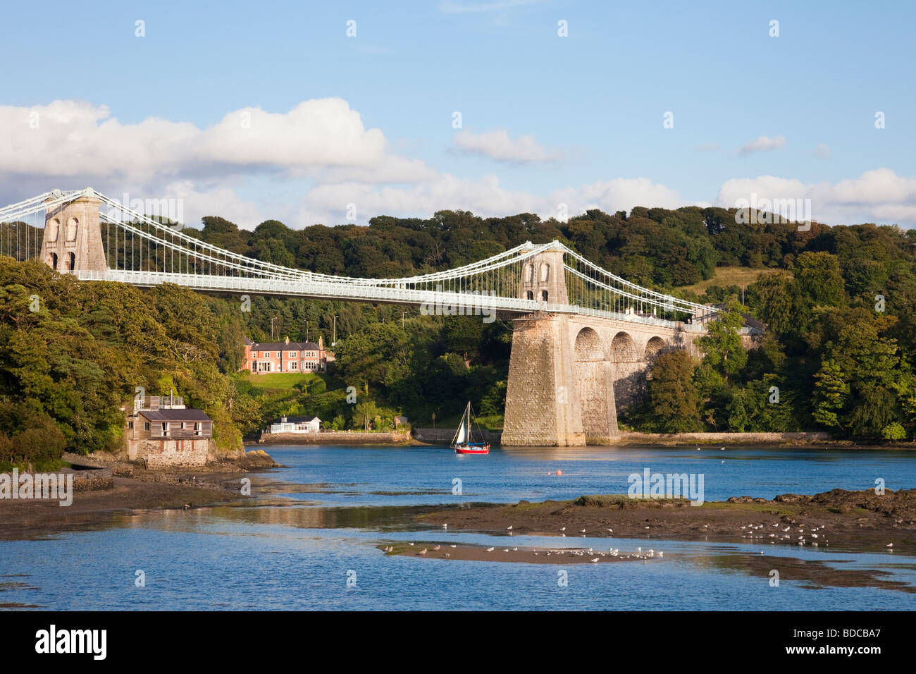Menai suspension bridge across Menai Straits in summer. Menai Bridge ...