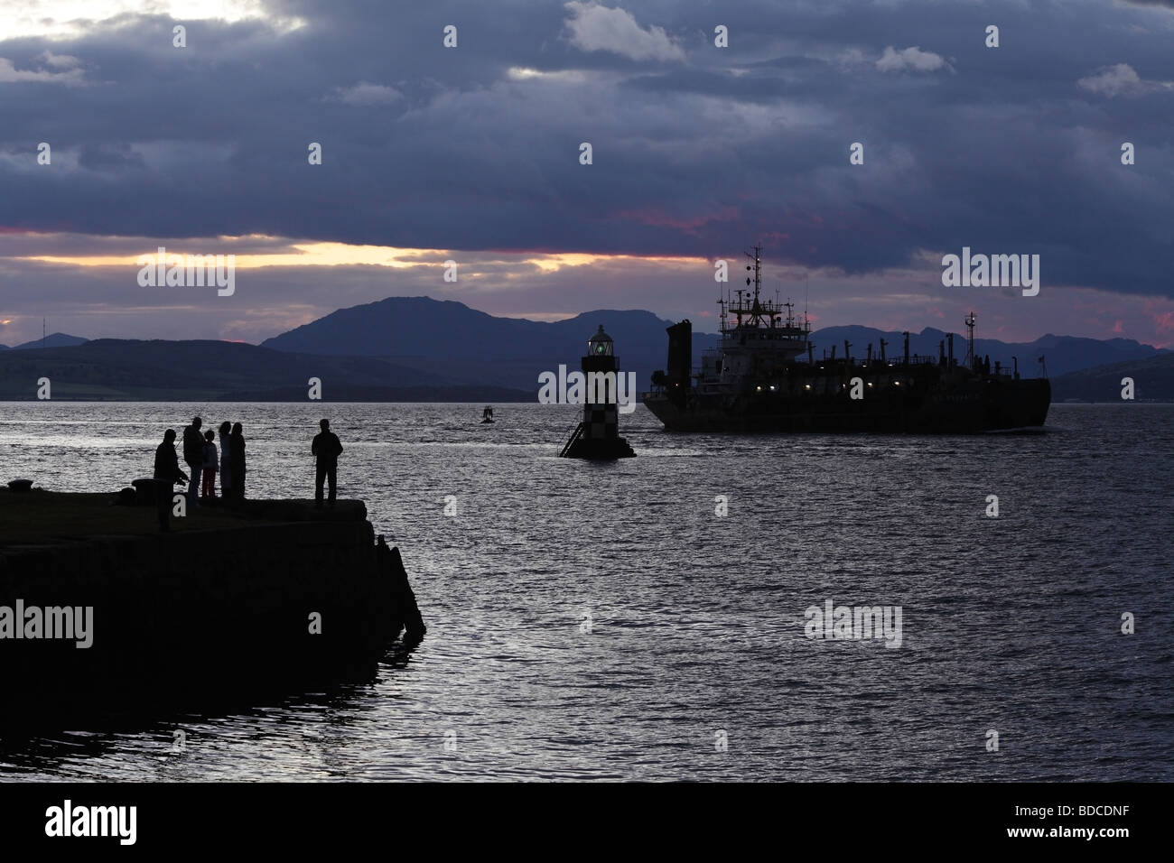 Group of people at sunset watching a ship sailing by the Perch ...