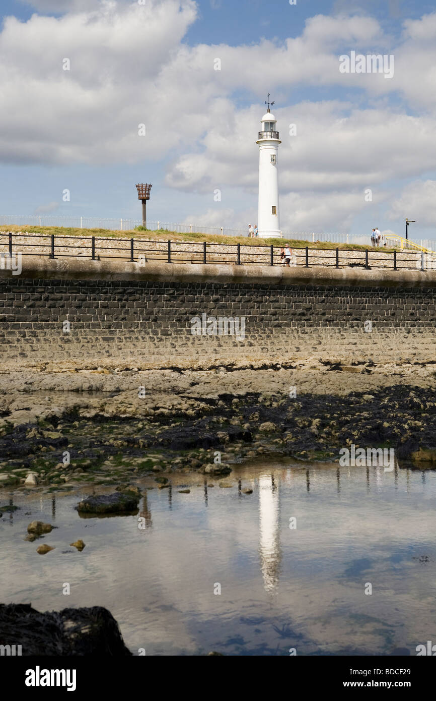The old Roker cast iron lighthouse and brazier reflected in rockpool ...