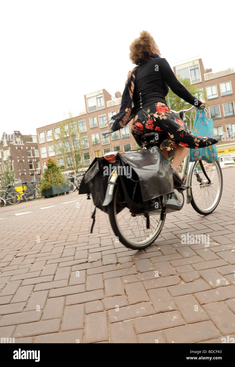 Mature woman riding bicycle in Amsterdam, Holland Stock Photo - Alamy
