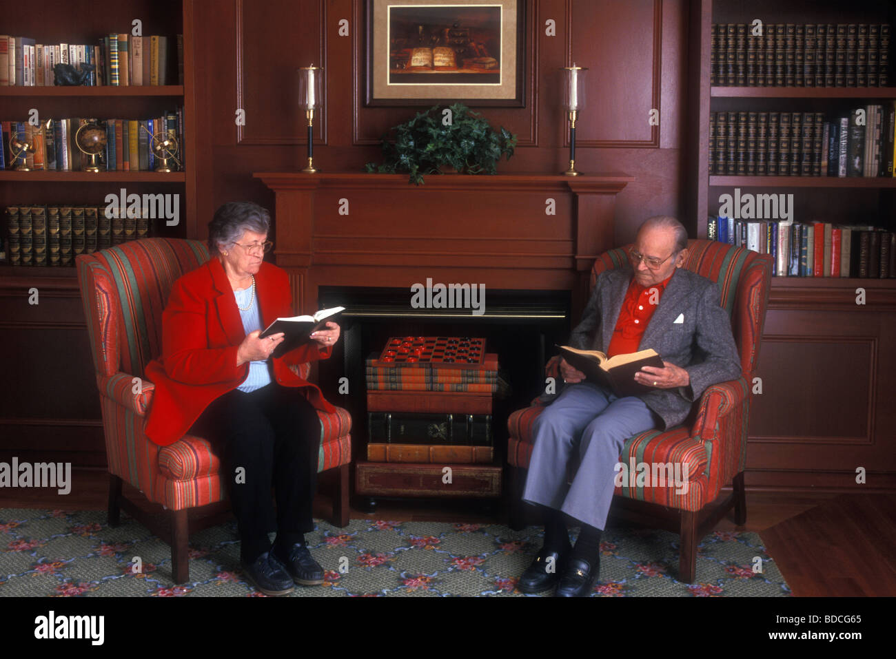 senior citizens reading books in library at assisted living home Stock ...