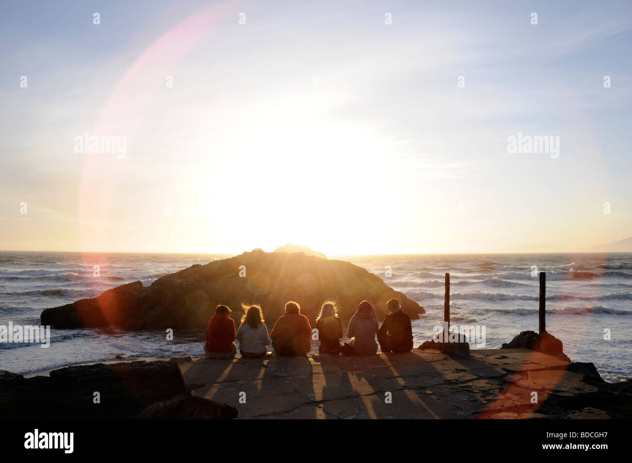 six friends chill out at sunset on Ocean Beach in San Francisco ...