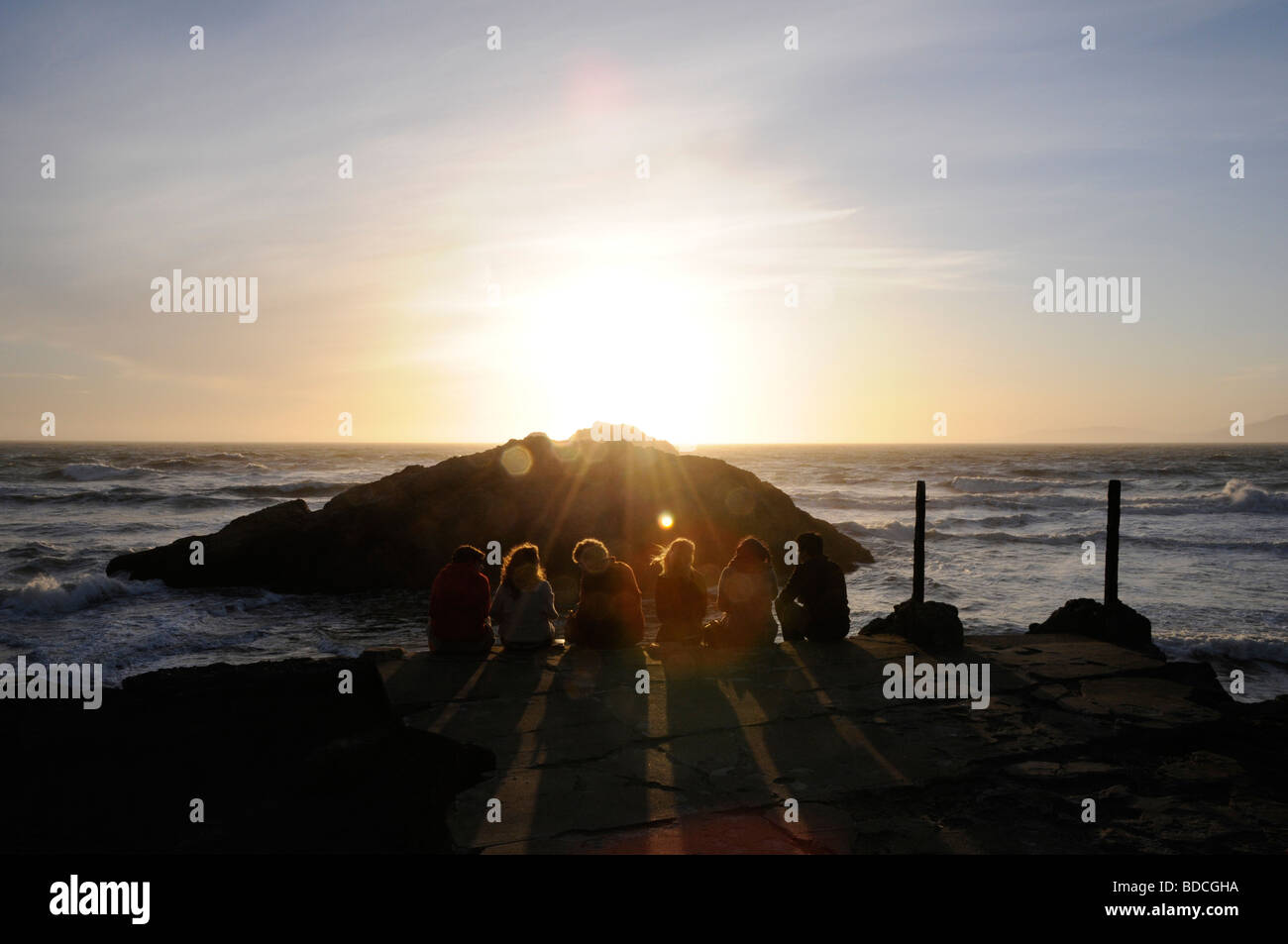 six friends chill out at sunset on Ocean Beach in San Francisco ...