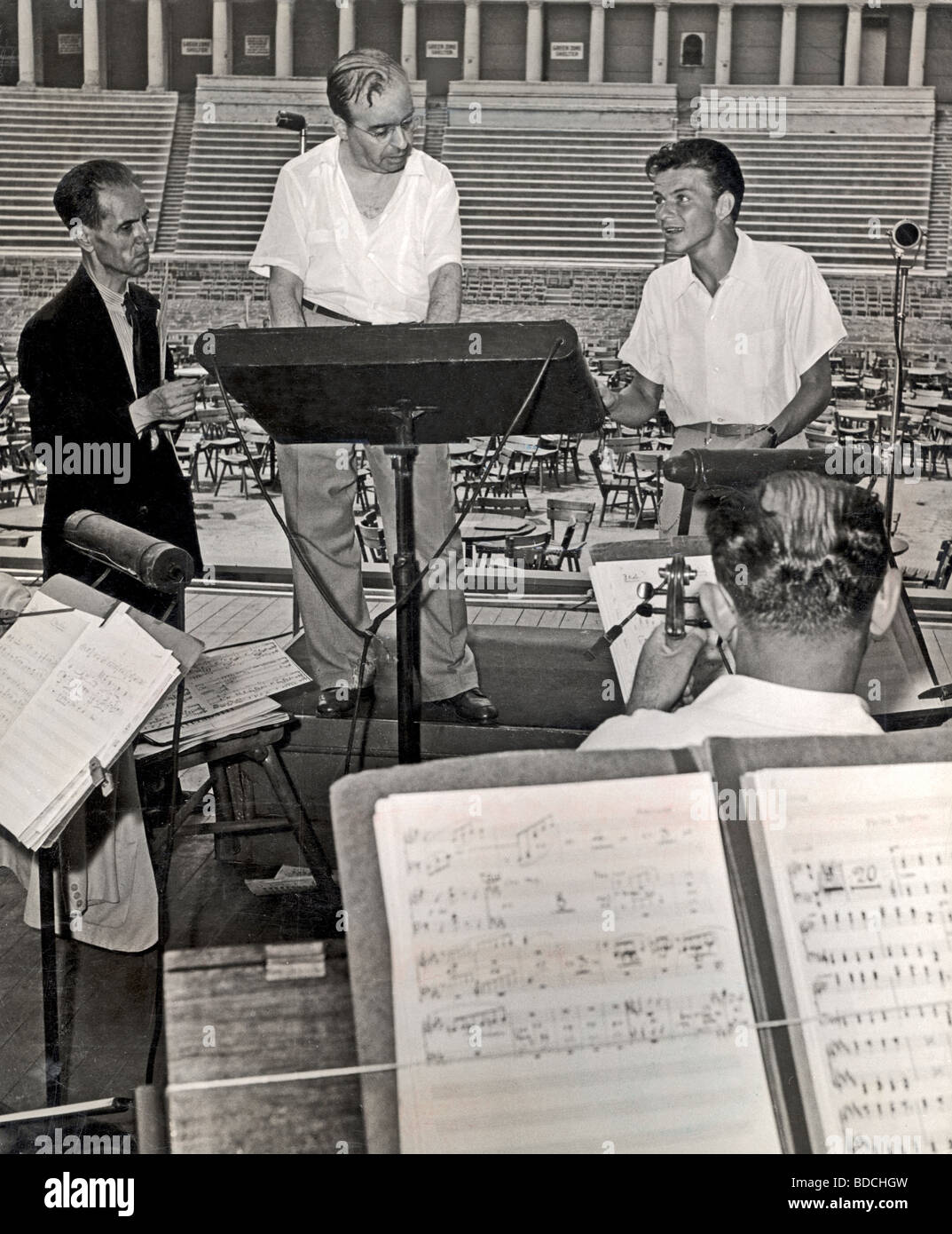 FRANK SINATRA at the Hollywood Bowl in 1943 with film composer Max Steiner conducting Stock ...