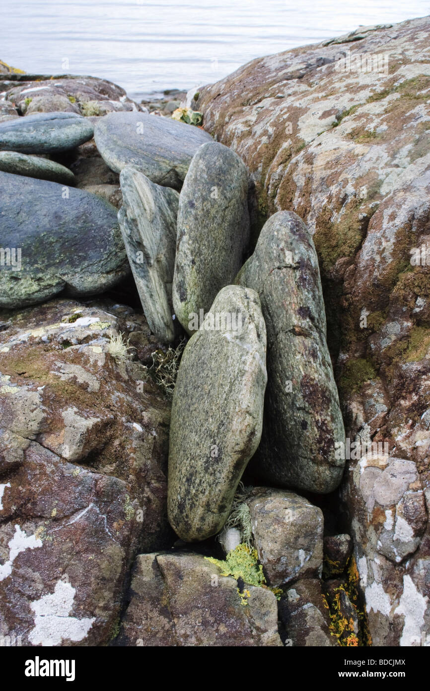 Rock with boulders wedged into crevice Stock Photo - Alamy