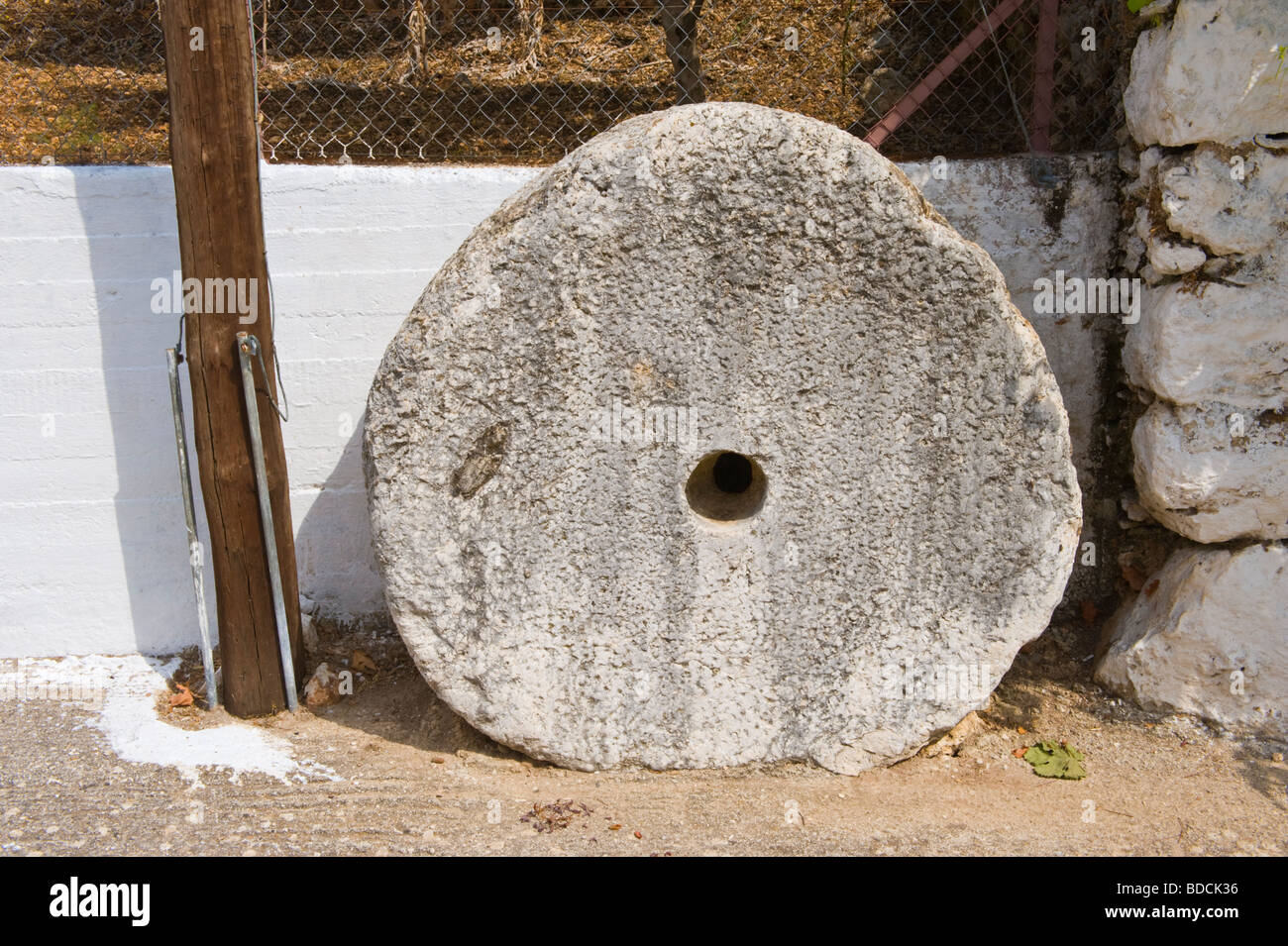 Old millstone in the village of Arginia on the Greek island of ...