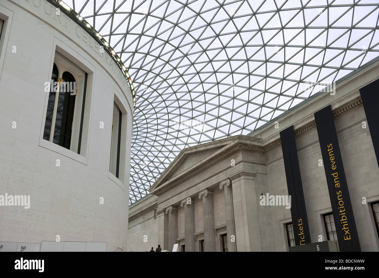 Interior glass roofed central atrium with exhibition banners inside the ...