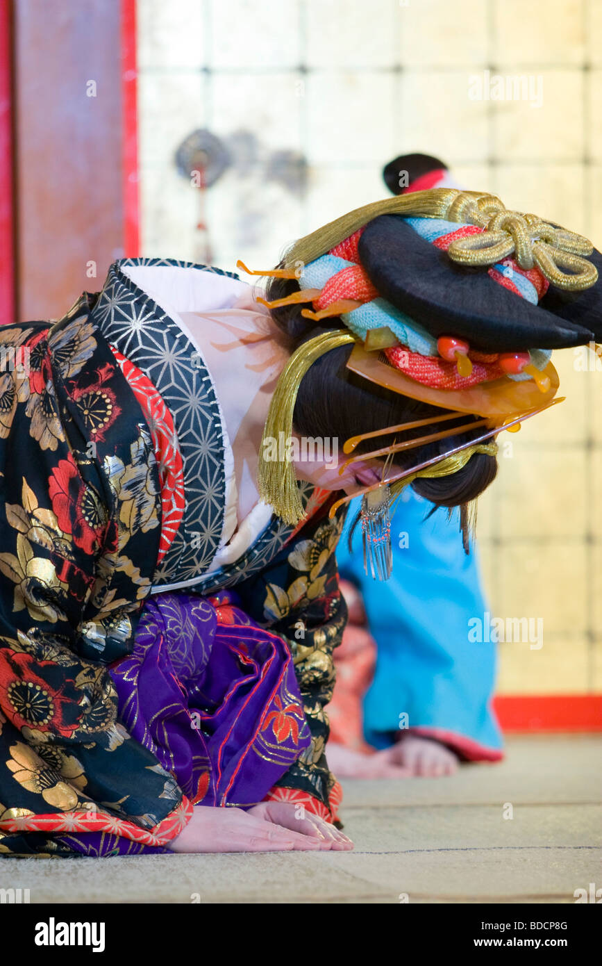 A female performer dressed in traditional geisha outfit performs on ...