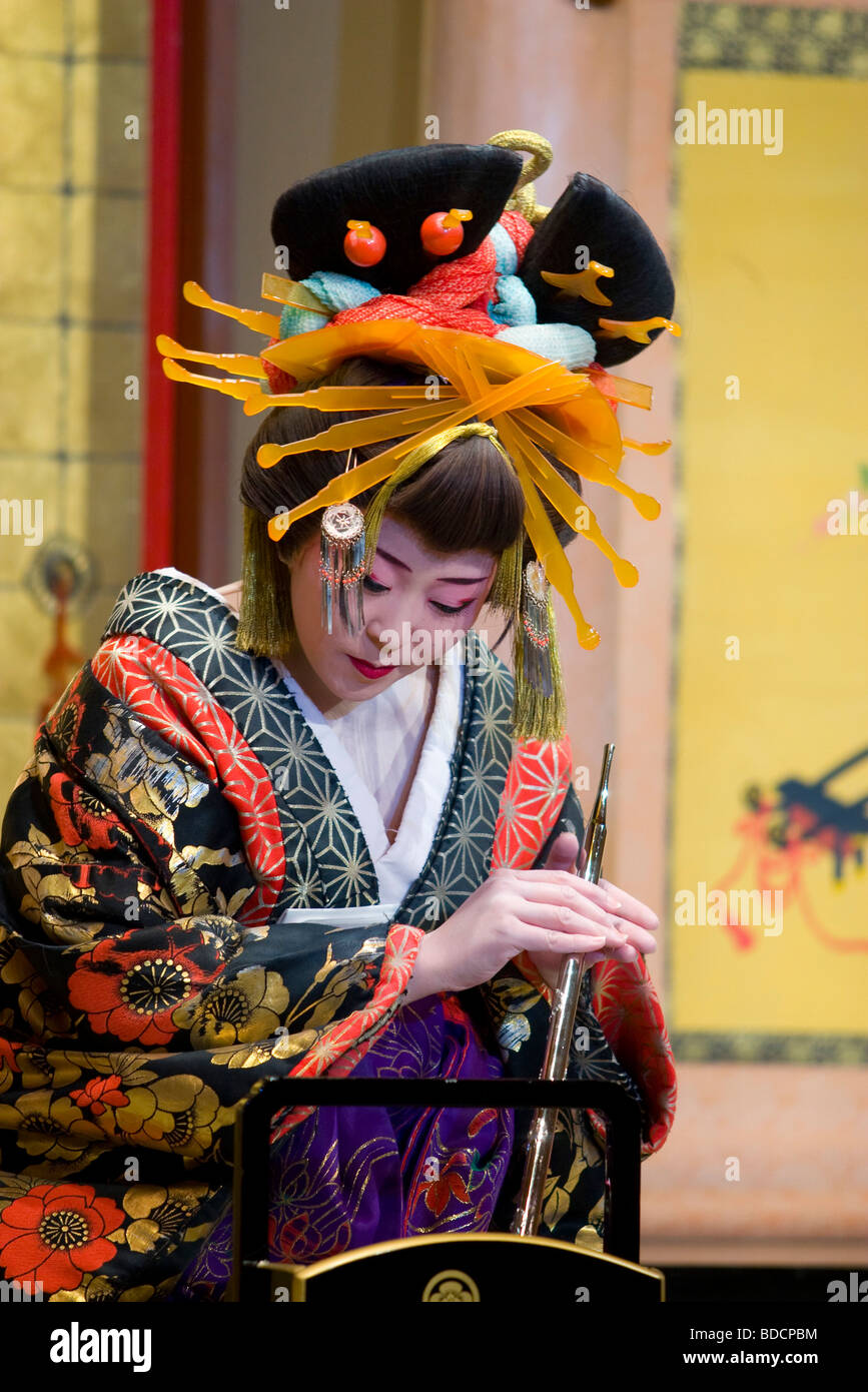 A female performer dressed in traditional geisha outfit performs on ...