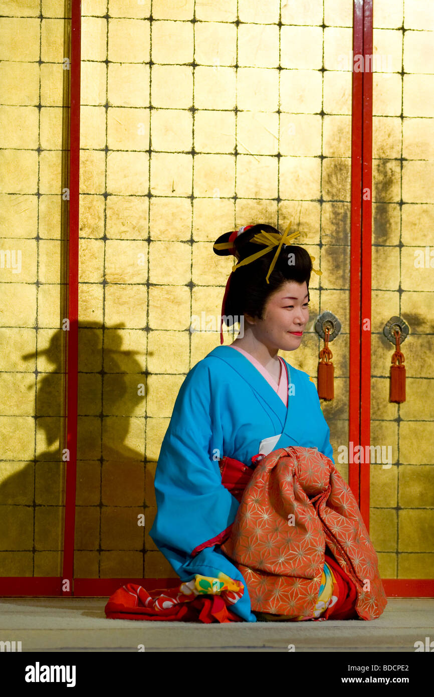 A female performer dressed in traditional geisha outfit performs on ...