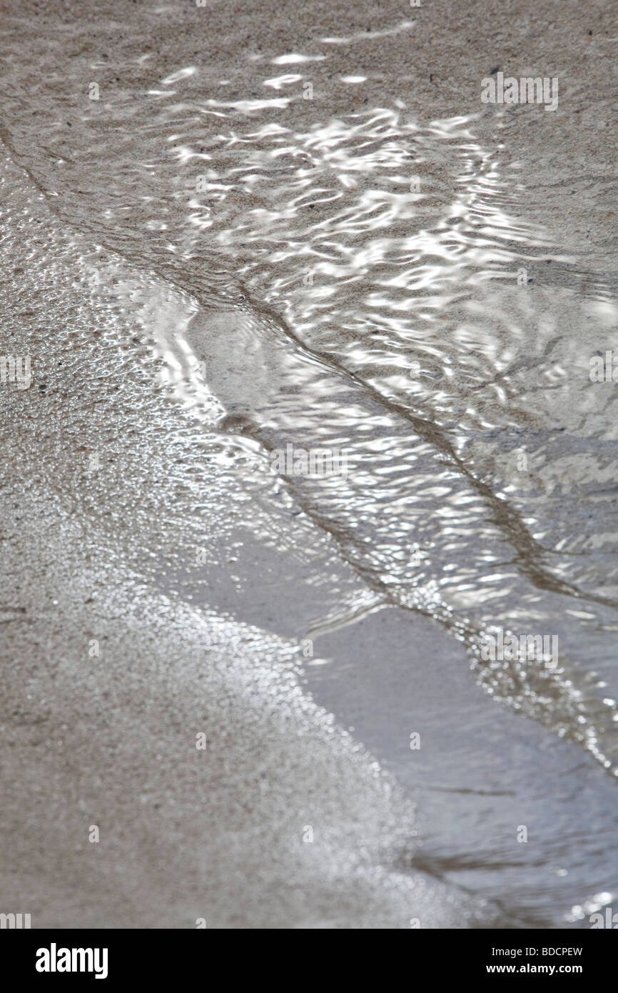 Close up of the ocean washing onto a beach on a tropical island in The ...
