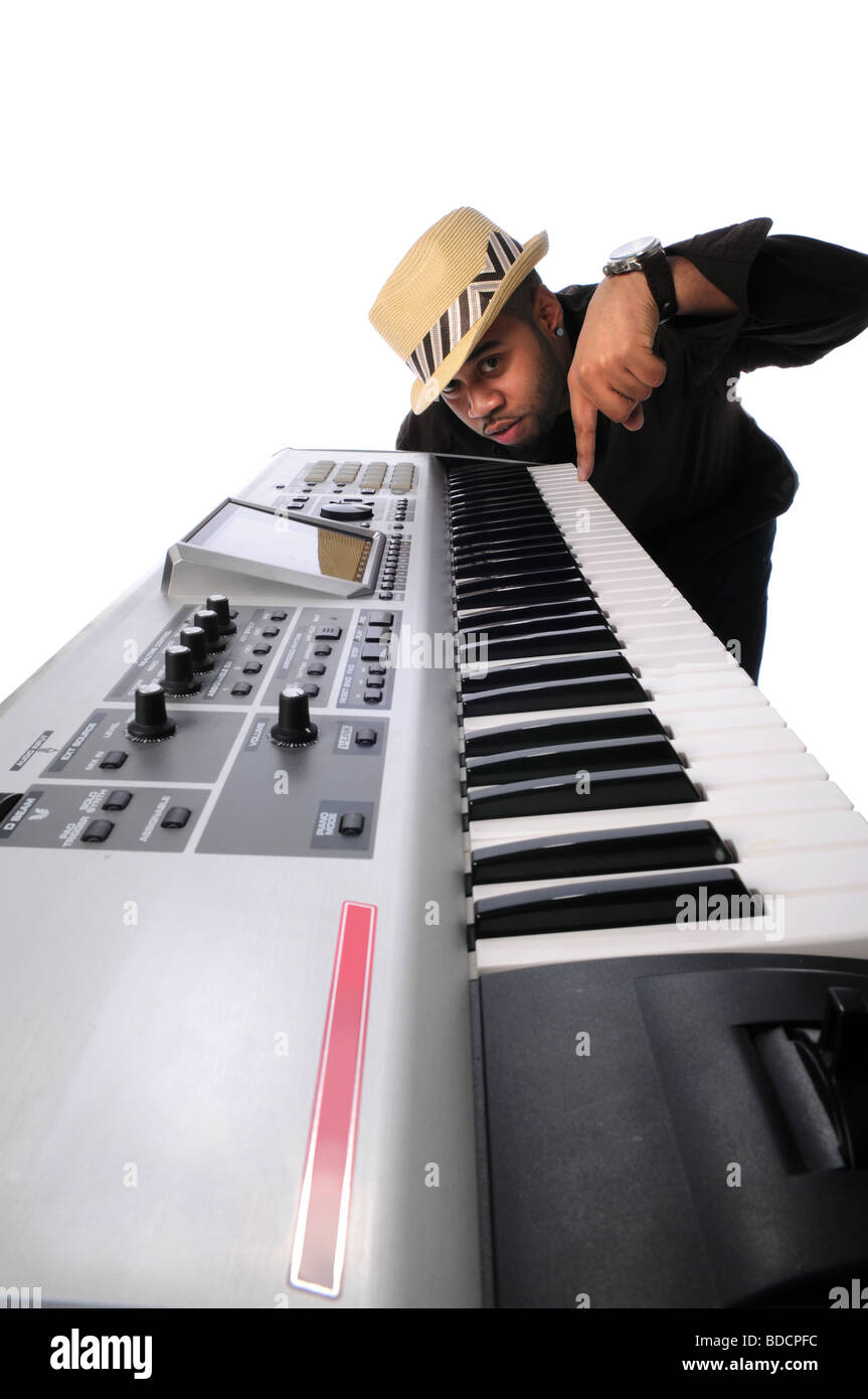 African American musician with electronic keyboard isolated over white ...