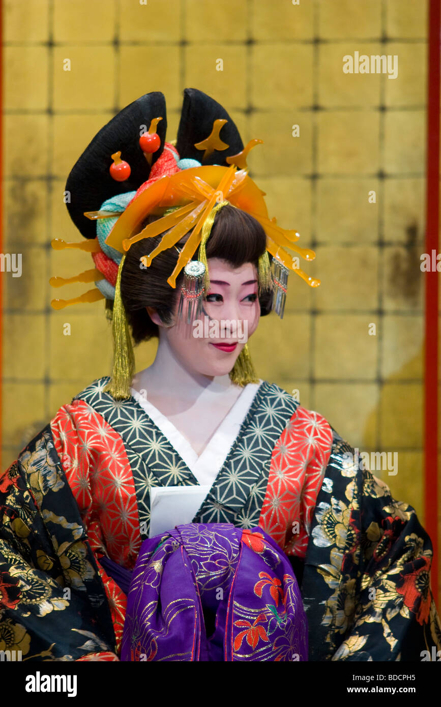 A female performer dressed in traditional geisha outfit performs on ...