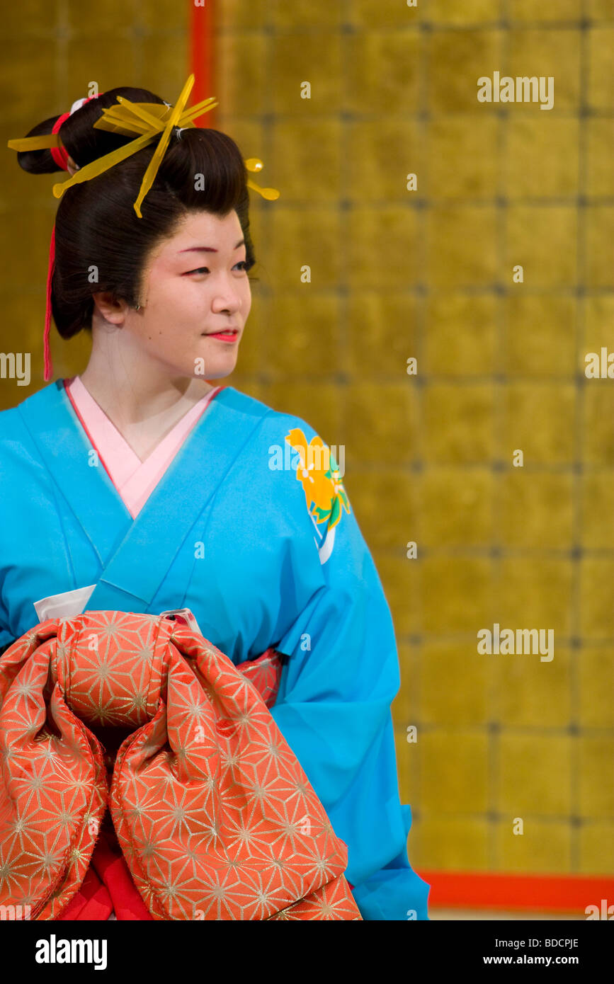 A female performer dressed in traditional geisha outfit performs on ...