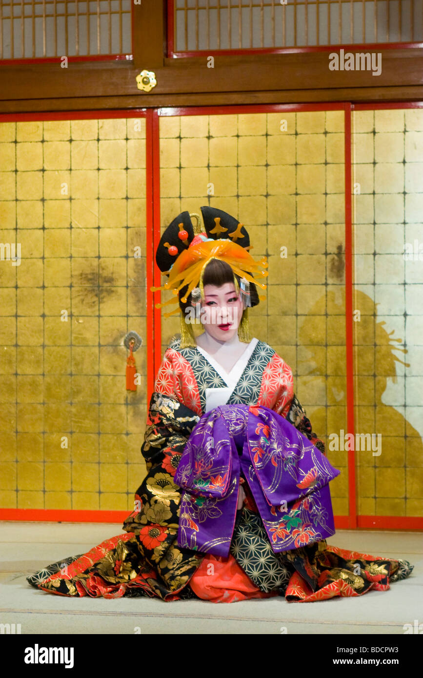 A female performer dressed in traditional geisha outfit performs on ...