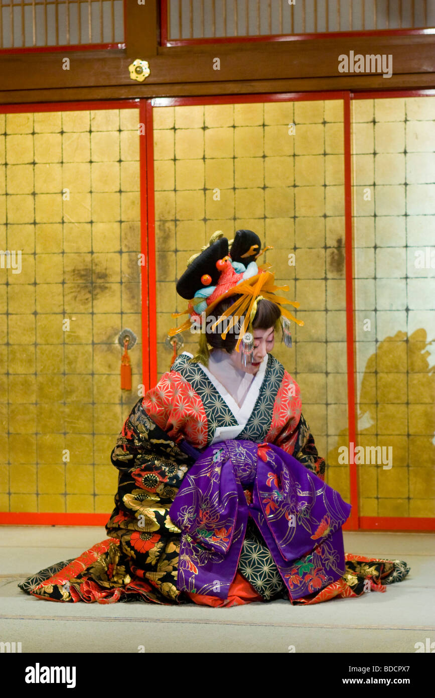 A female performer dressed in traditional geisha outfit performs on ...