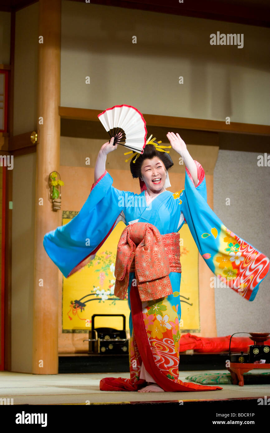 A female performer dressed in traditional geisha outfit performs on ...