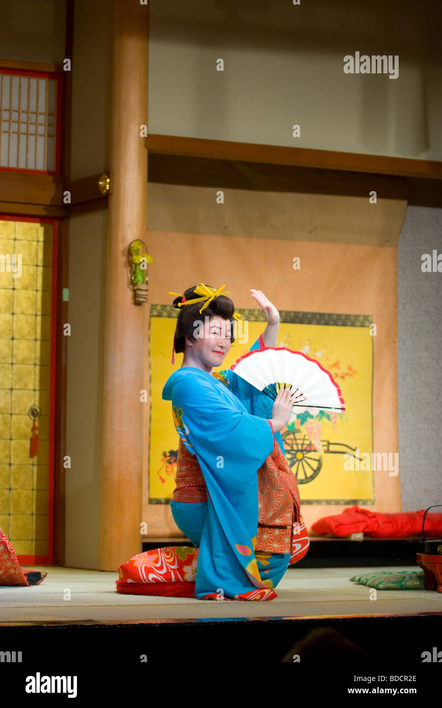 A female performer dressed in traditional geisha outfit performs on ...